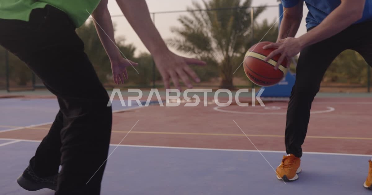 A team of Saudi Gulf Arab friends playing basketball, practicing ...