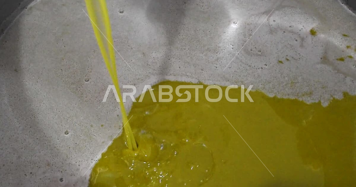 Close-up of olive oil production, olive press, olive squeezing process ...