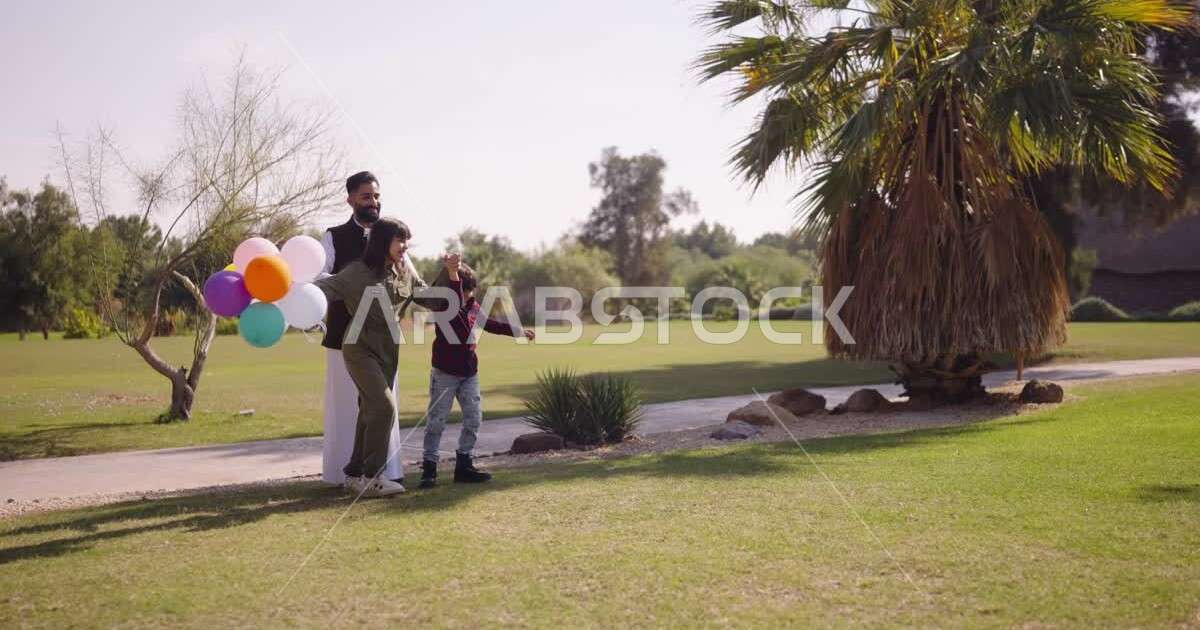 A Saudi Arabian Gulf man spends fun times with his family in a park in ...