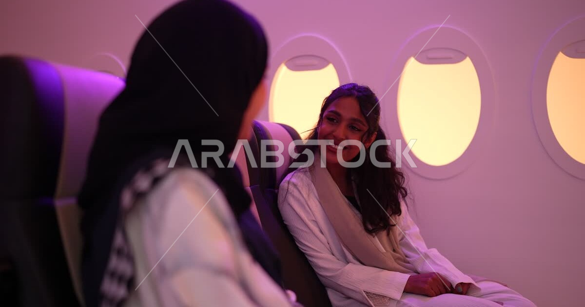 Two Saudi Arabian Gulf female travelers inside the plane, dialogues and ...