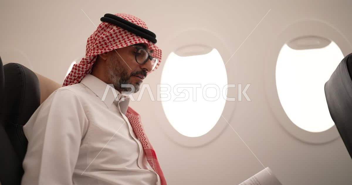 A Saudi Gulf Arab man inside the plane, wearing medical glasses ...