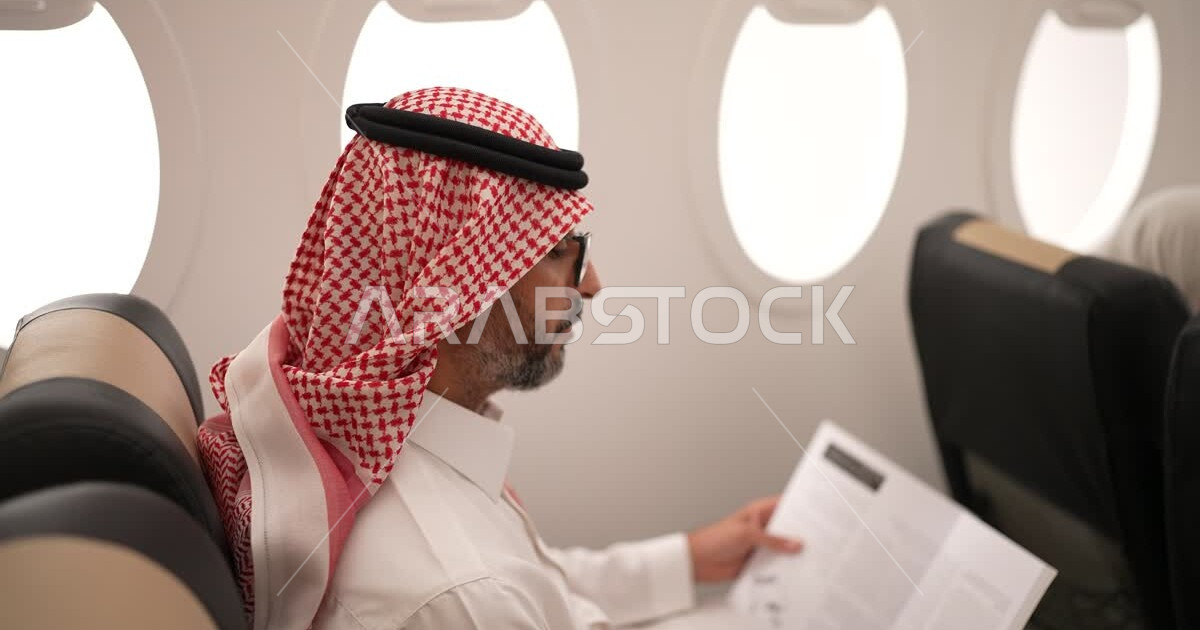 A Saudi Gulf Arab man inside the plane, wearing medical glasses ...