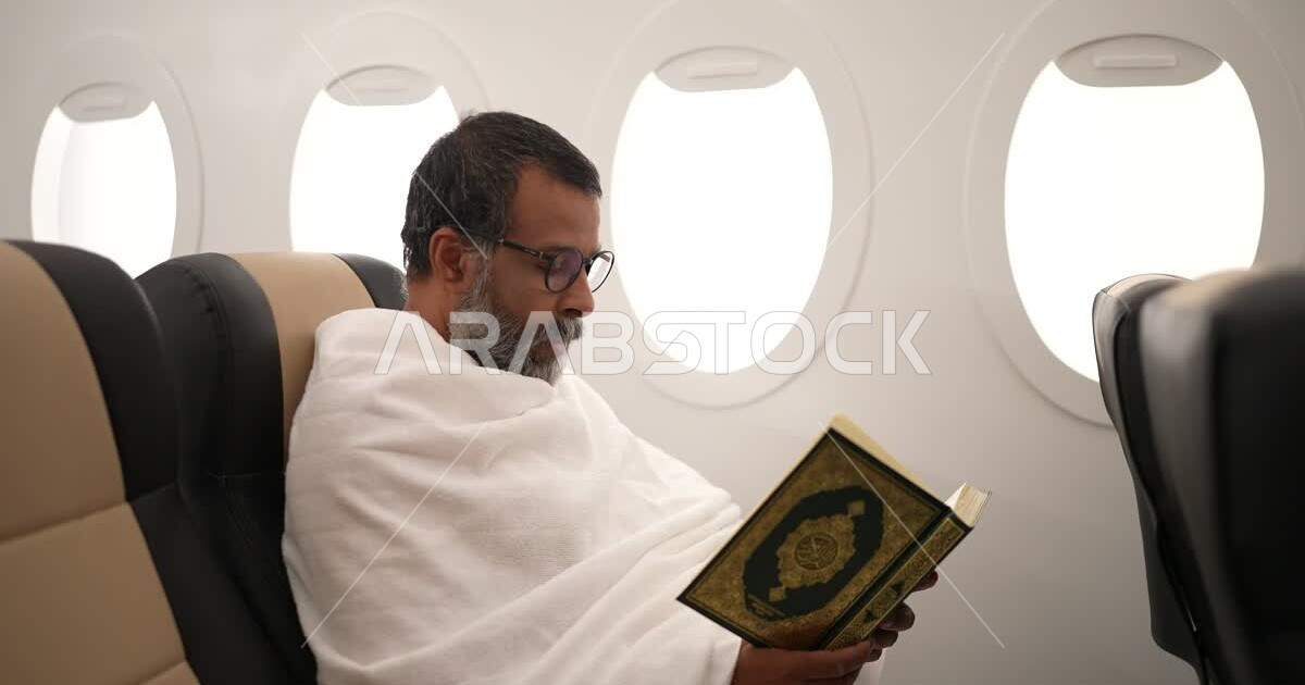 A Saudi Arabian Gulf man from inside the plane, wearing medical glasses ...