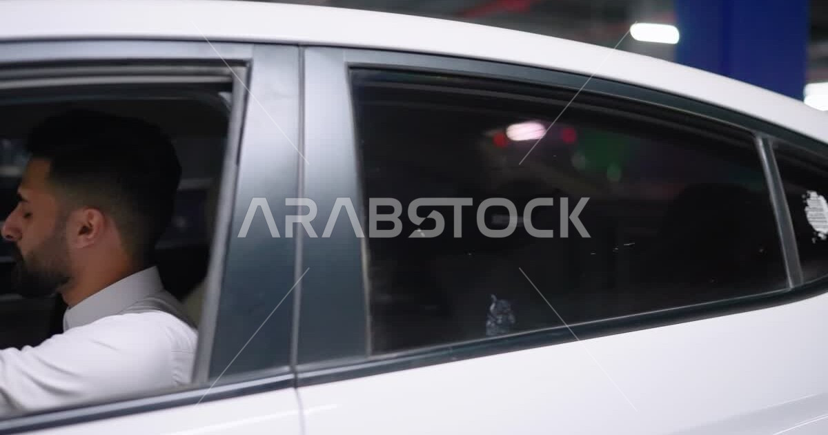 A Saudi Arabian Gulf man parks the car in the parking lot of The Zone ...