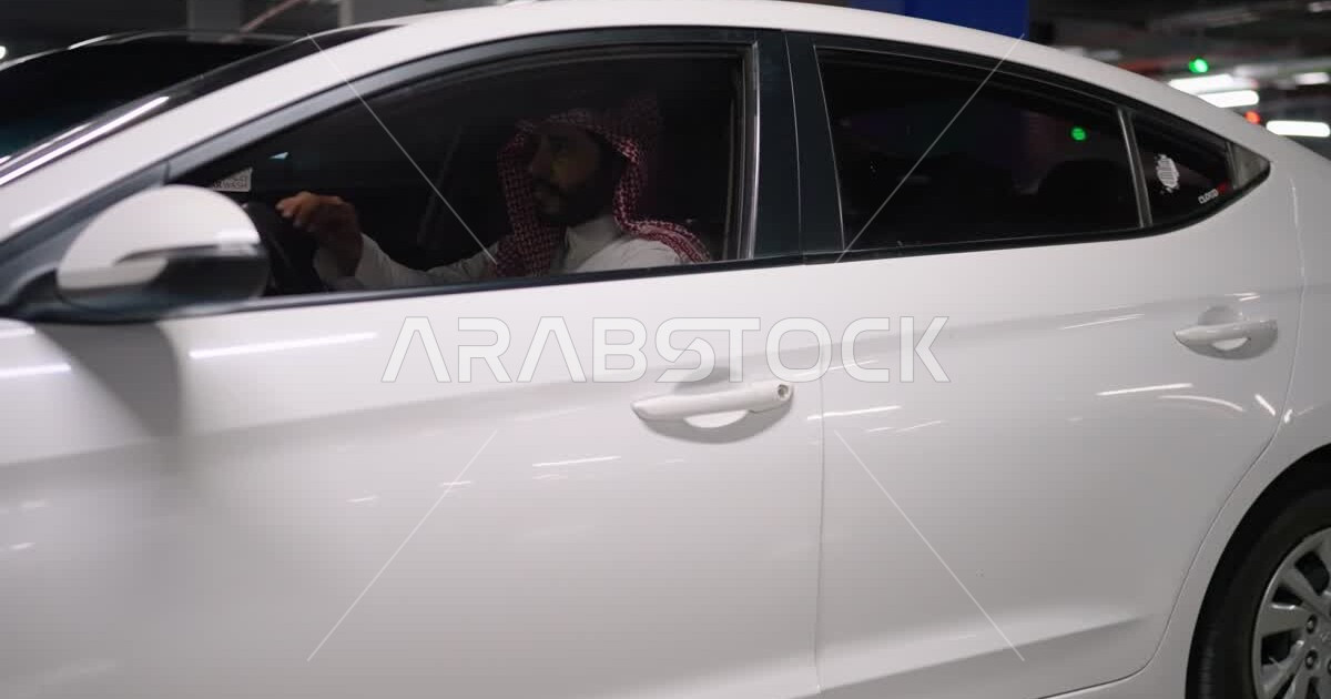 A Saudi Arabian Gulf man parks the car in the parking lot of The Zone ...