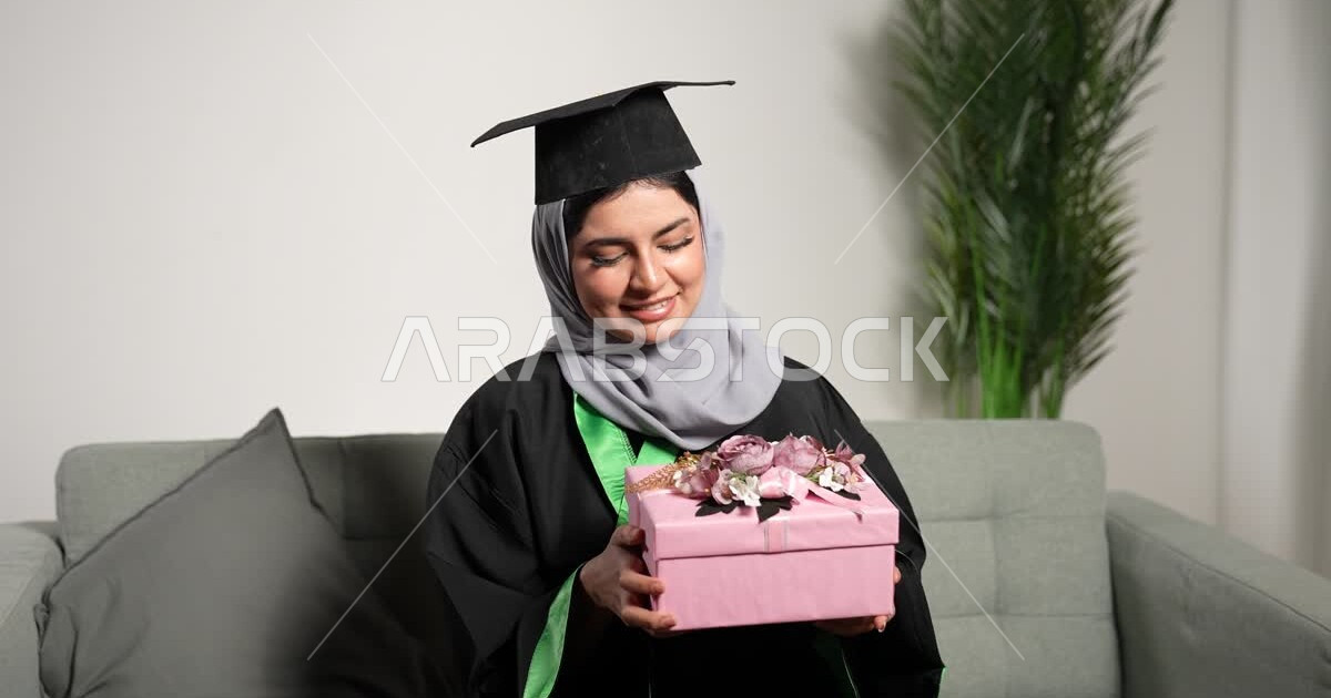 Smiling Saudi Arab Gulf woman, wearing abaya and graduation hat ...