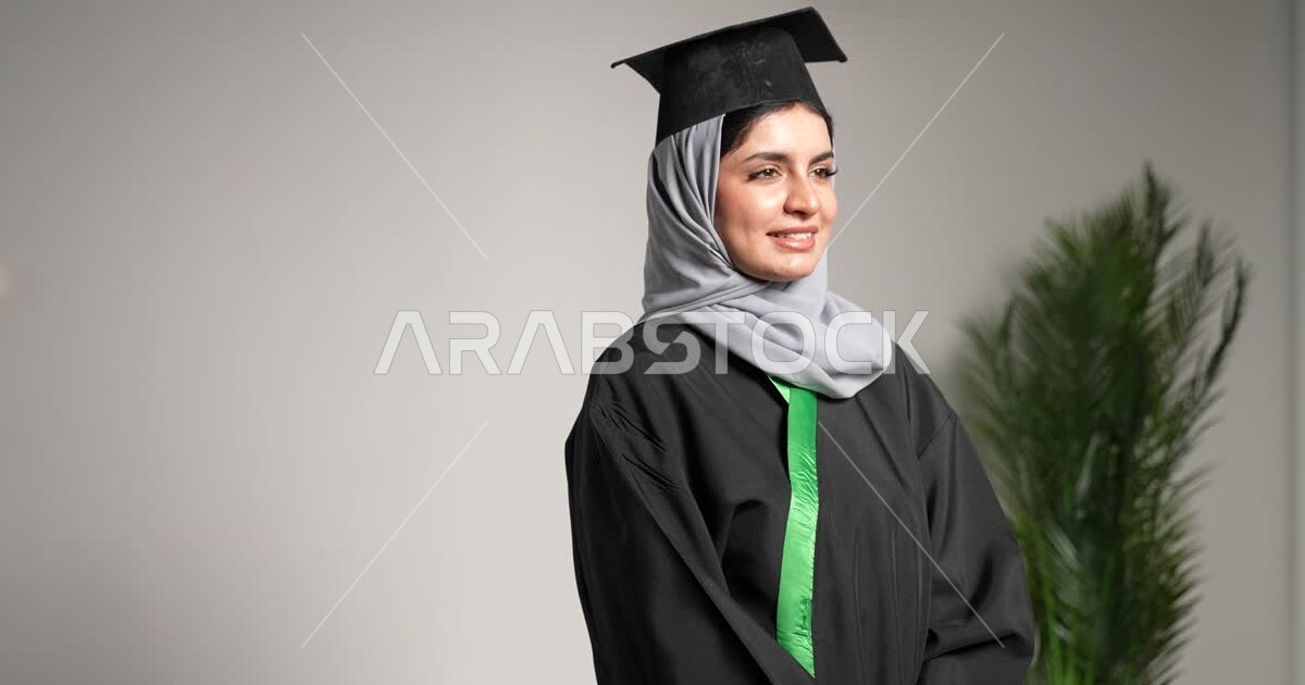 Smiling Saudi Arabian Gulf woman, wearing abaya and graduation cap ...