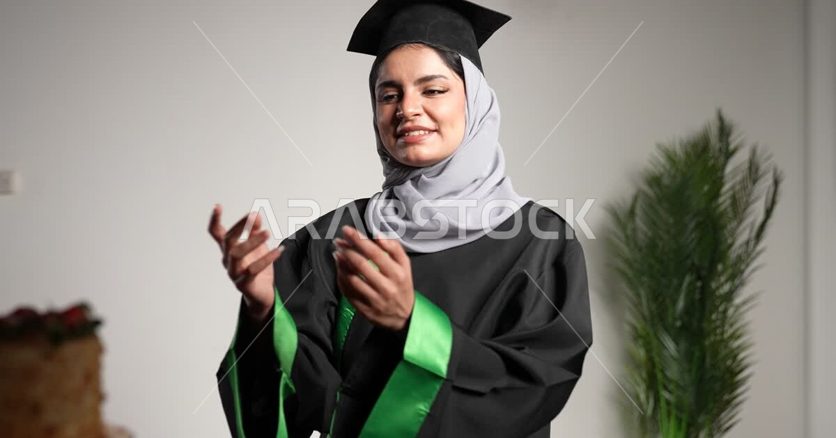 Smiling Saudi Gulf Arab woman, wearing abaya and graduation hat ...