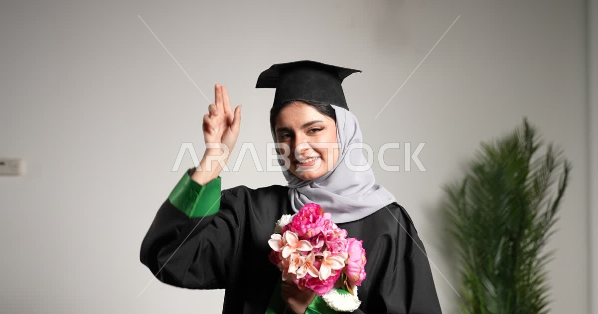 Smiling Saudi Arab Gulf woman, wearing abaya and graduation hat ...