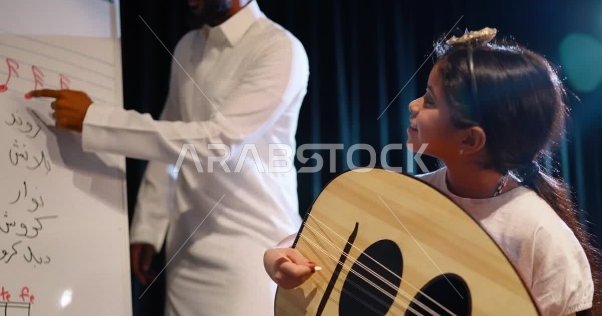 A Saudi Arabian Gulf man giving music lessons, a Saudi Arab girl ...