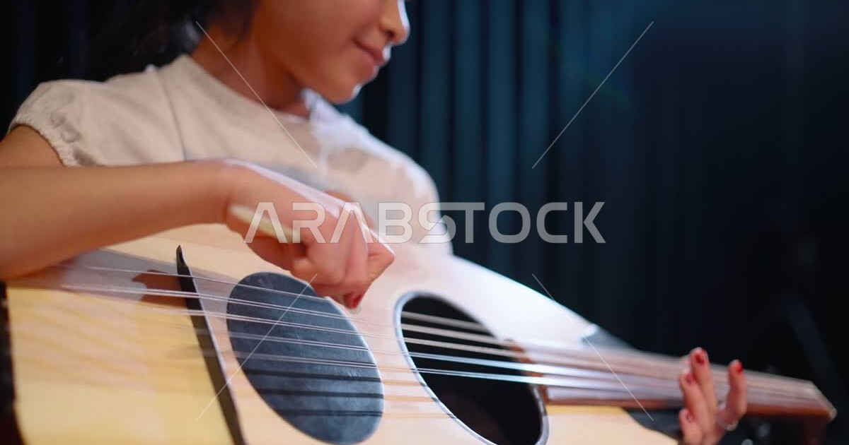 A Saudi Gulf Arab girl plays the Oud, musical instruments, spending ...