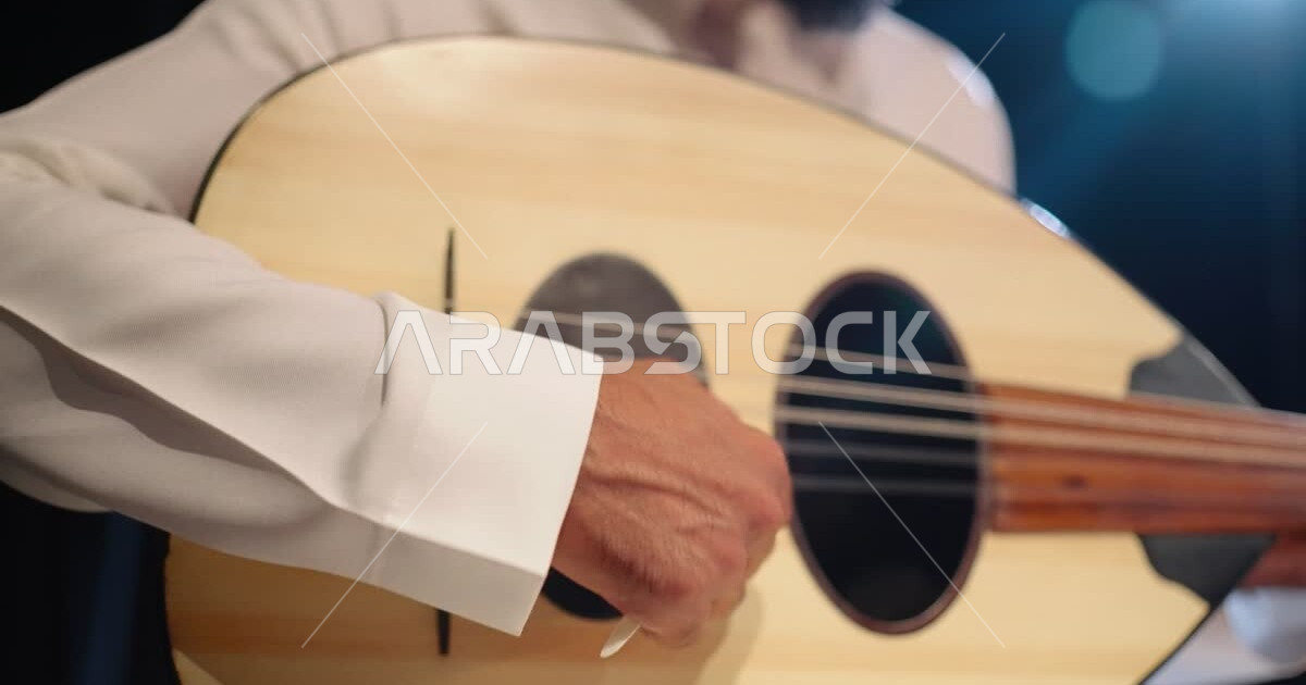 Close-up of a Saudi Arabian Gulf man playing the Oud, a musical ...