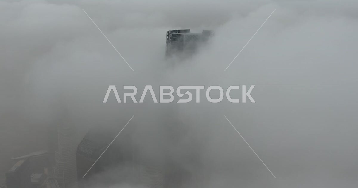 Fog embraces the towers and skyscrapers of the Saudi capital in Riyadh ...