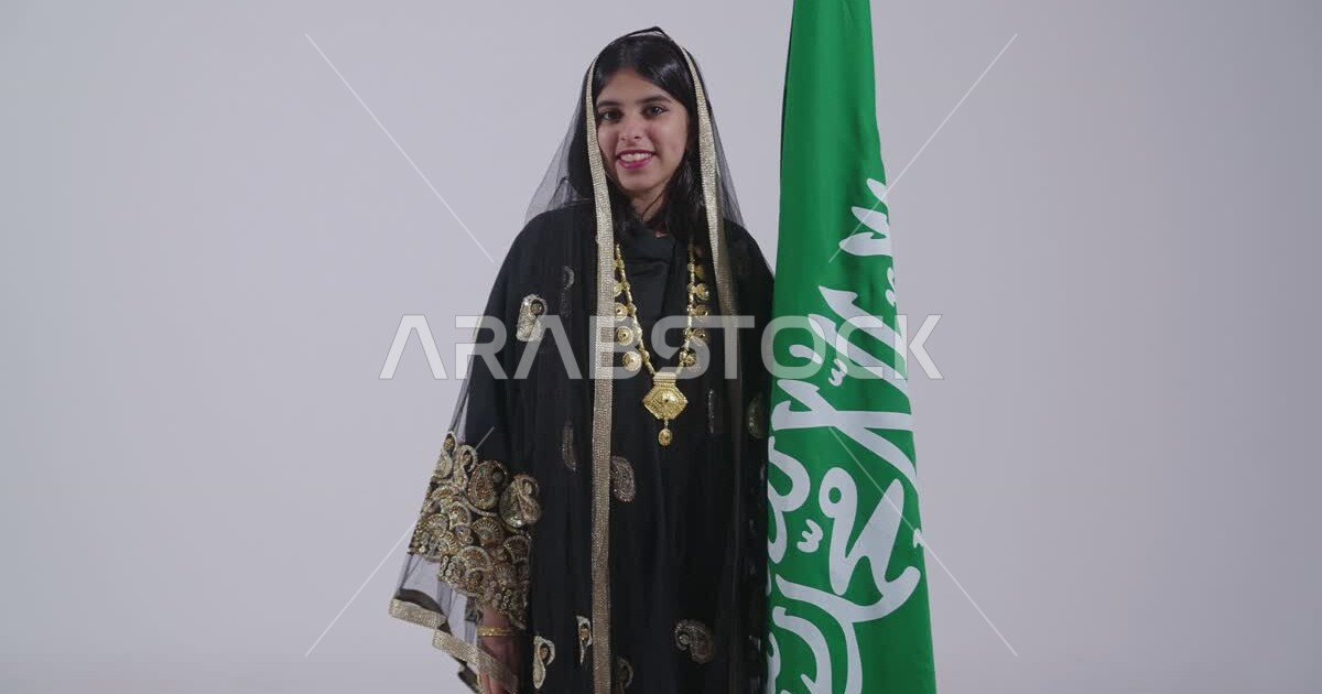 Chroma, a Saudi Arab Gulf girl carrying the Saudi flag, wearing the ...
