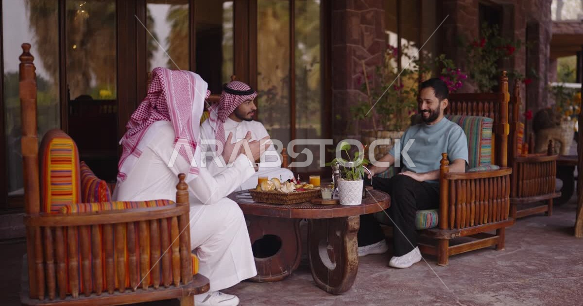 Saudi Gulf Arab youth sitting in a cafe and enjoying the exchange of ...