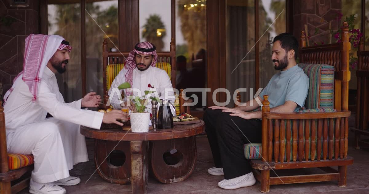 Saudi Gulf Arab youth sitting in a cafe and enjoying the exchange of ...