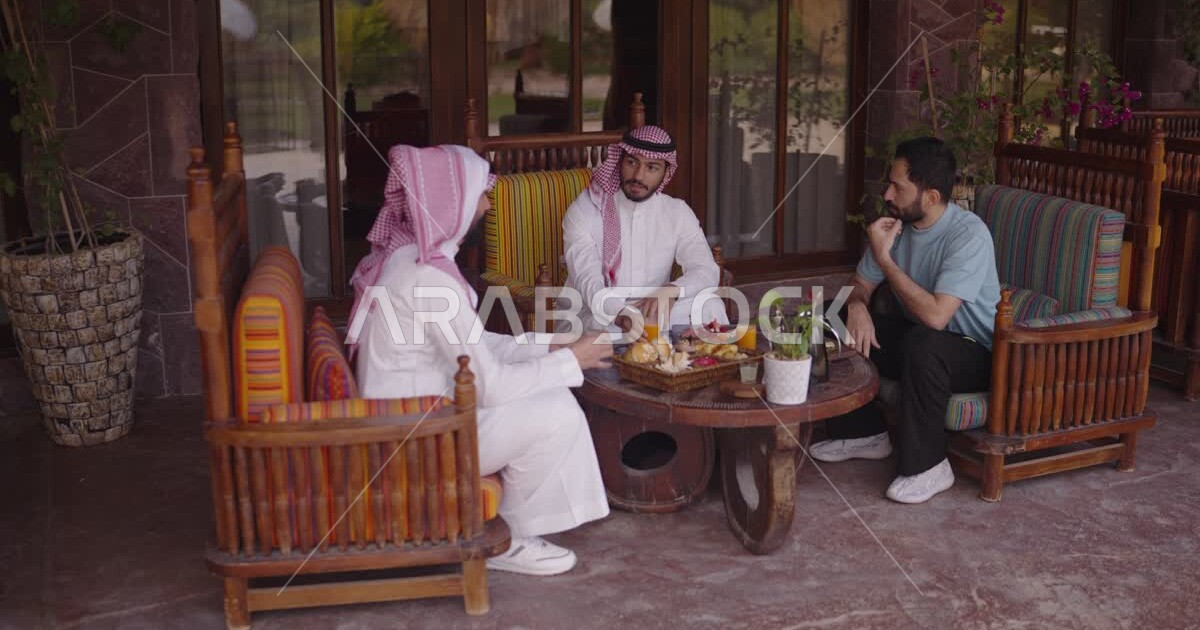 Saudi Gulf Arab youth sitting in a cafe and enjoying the exchange of ...