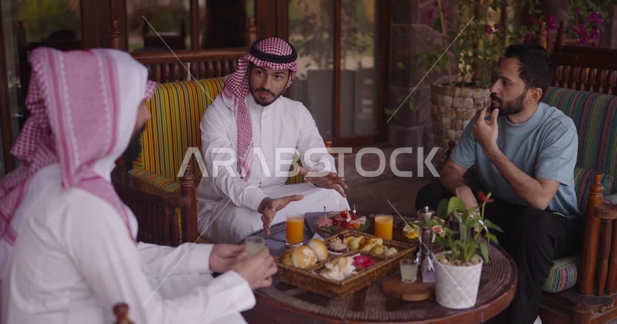 Saudi Gulf Arab youth sitting in a cafe and enjoying the exchange of ...
