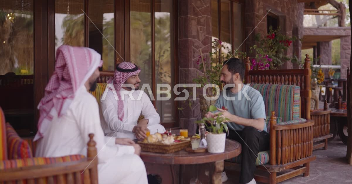 Saudi Gulf Arab youth sitting in a cafe and enjoying the exchange of ...