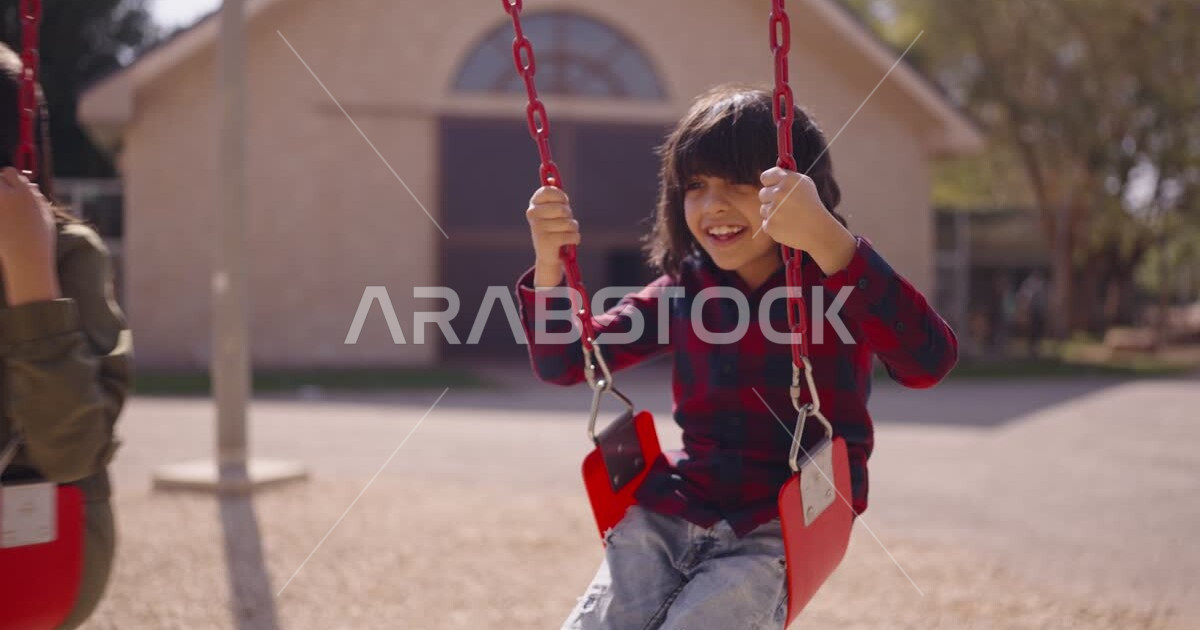 A Saudi Gulf Arab boy and girl in one of the recreational parks in ...