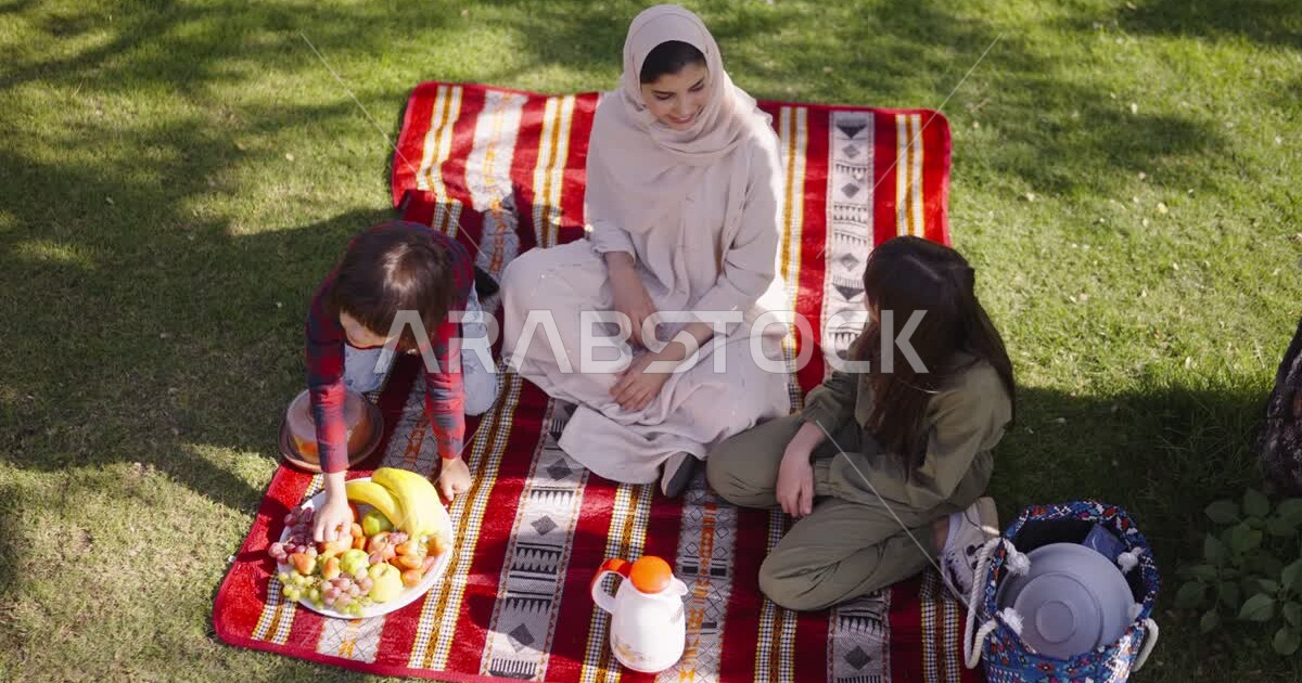 A Saudi Arab Gulf mother spends fun times with her family in a public ...