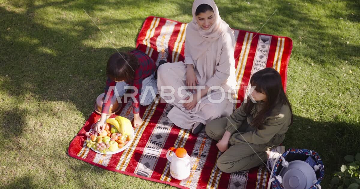 A Saudi Arab Gulf mother spends fun times with her family in a public ...