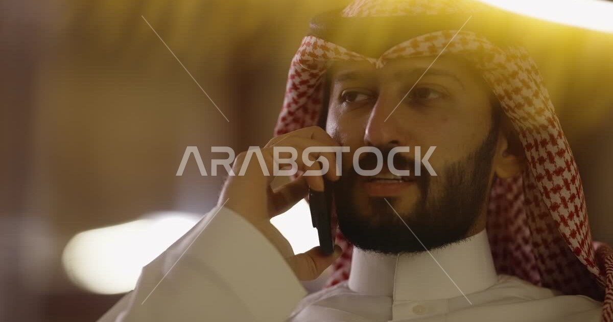 A Saudi Arabian Gulf man making a phone call using a mobile phone ...