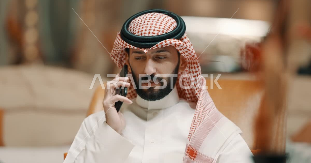 A Saudi Arabian Gulf man, making a phone call using a mobile phone ...