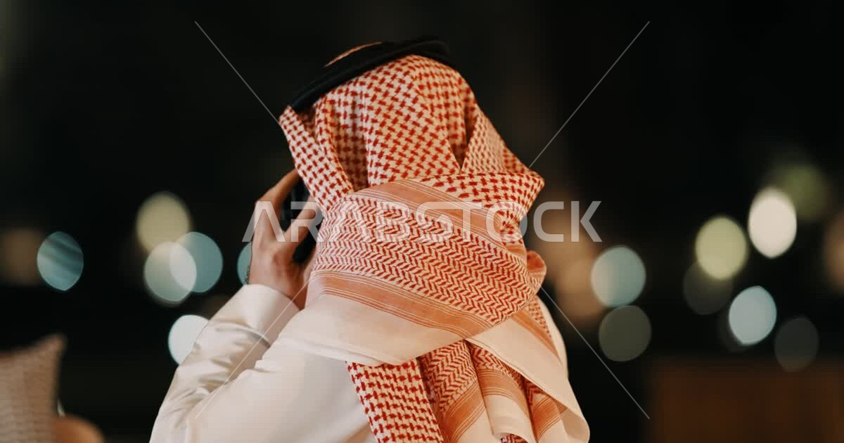 Close-up of a Saudi Arabian Gulf man, making a phone call using a ...