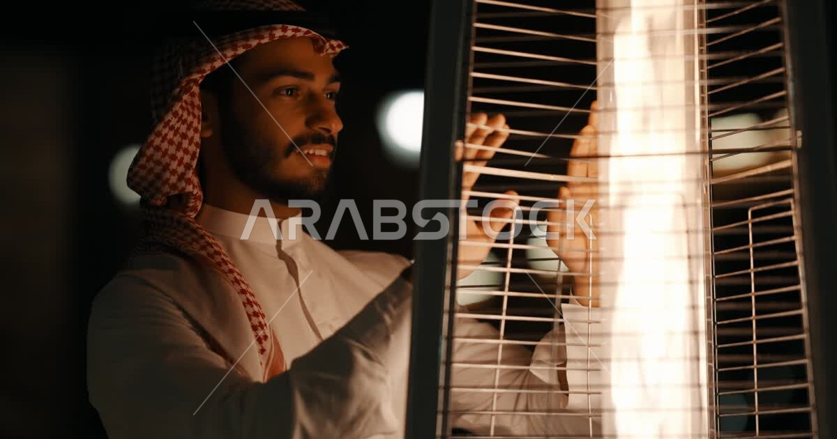 Saudi Arabian Gulf man, gas heater, outdoor seating, outdoor heater, winter weather - Video ...