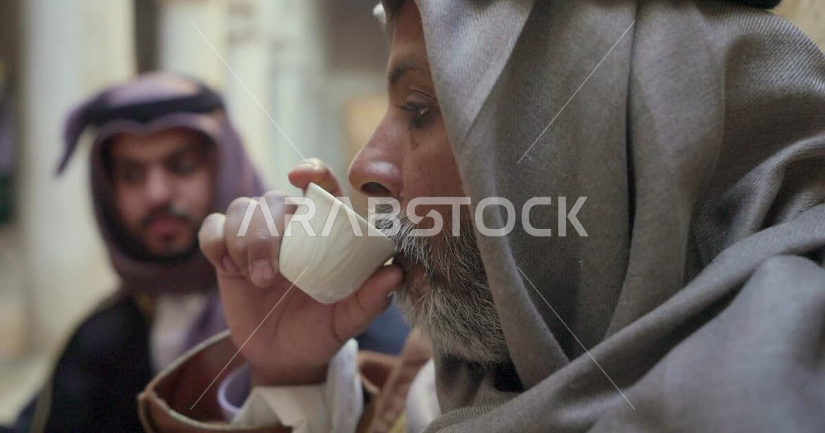 A close-up depiction of a Saudi Arabian Gulf man drinking hot Arabic ...