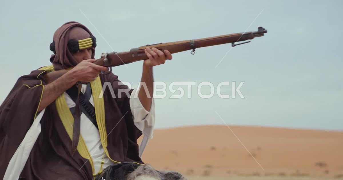 A Saudi Arab Gulf knight riding a horse in the desert and shooting ...