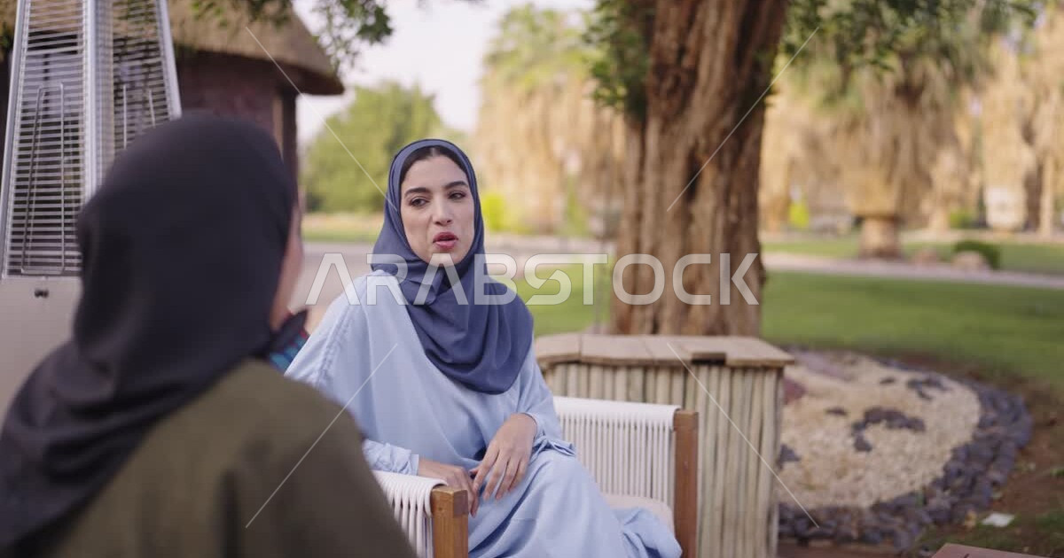 Two Saudi Arab Gulf women sitting in one of the public parks in the ...