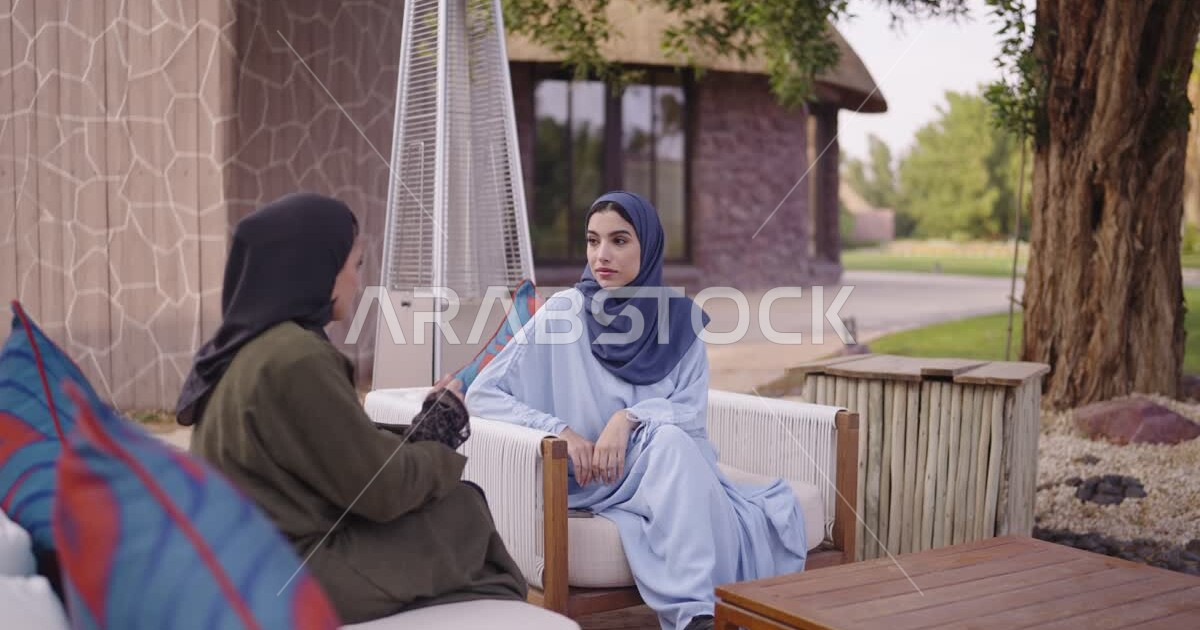 Two Saudi Arab Gulf women sitting in one of the public parks in the ...