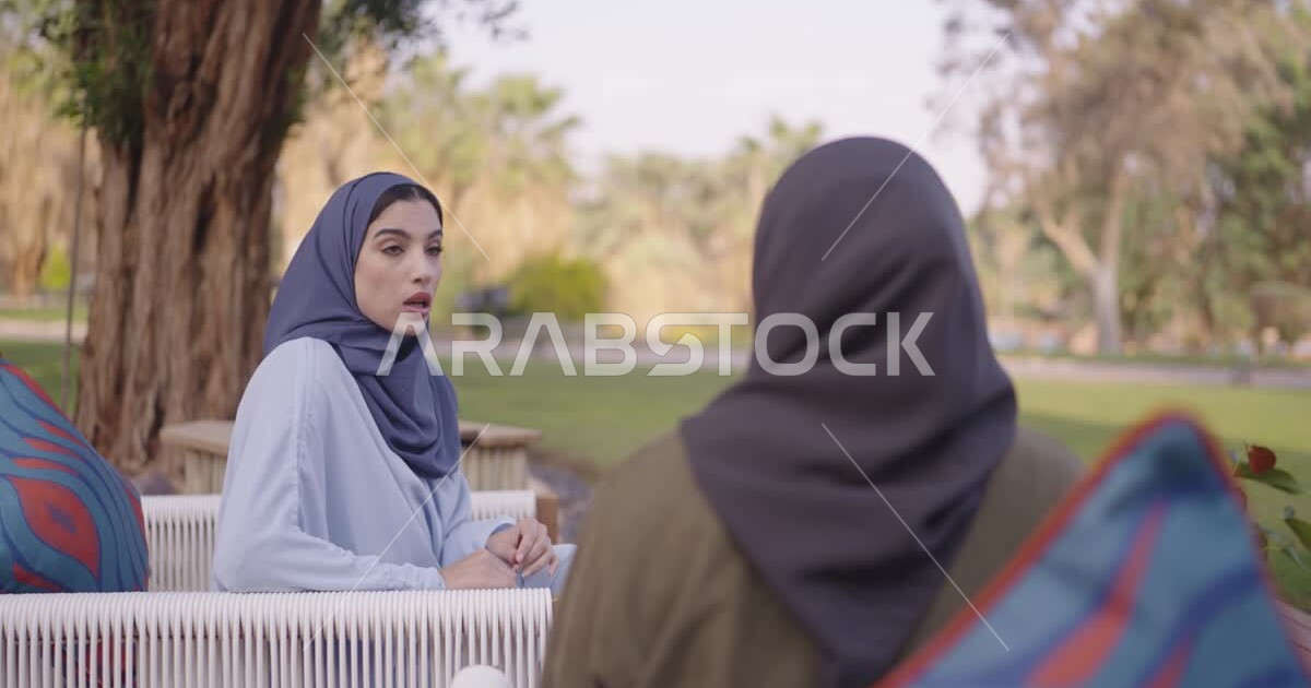 Two Saudi Arab Gulf women sitting in one of the public parks in the ...
