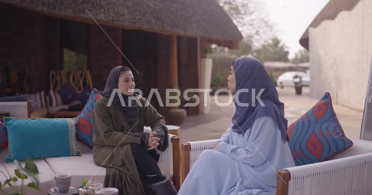 Two Saudi Arab Gulf women sitting in one of the public parks in the ...