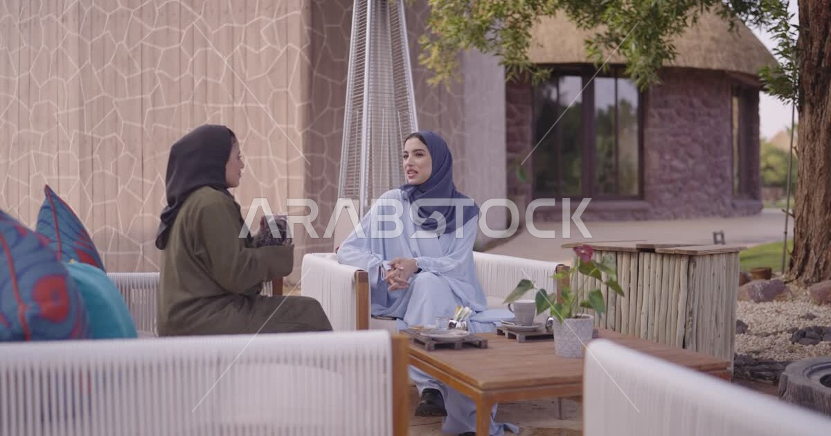 Two Saudi Arab Gulf women sitting in one of the public parks in the ...