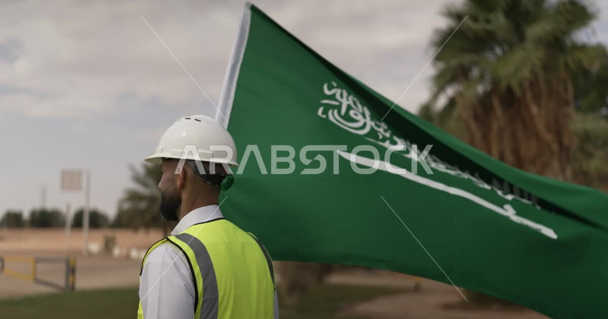 A Saudi Arabian Gulf solar energy engineer wearing a helmet and a ...