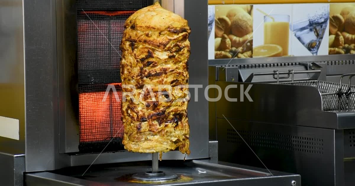 Rotating the shawarma skewer on the machine, Arab restaurants, fresh ...