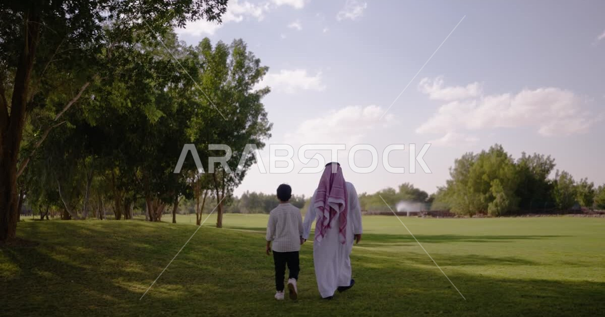 A Saudi Gulf Arab man spends fun times with his son, a tour in a public ...