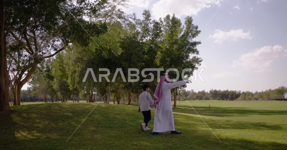 A Saudi Gulf Arab man spends fun times with his son, a tour in a public ...