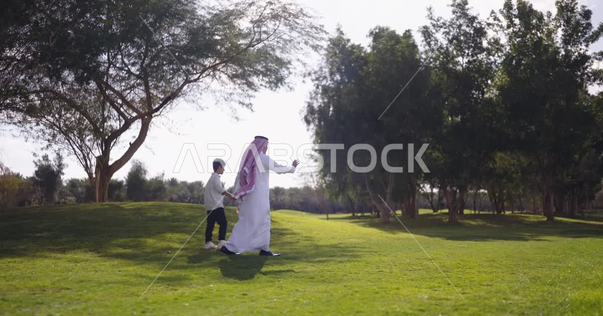 A Saudi Gulf Arab man spends fun times with his son, a tour in a public ...
