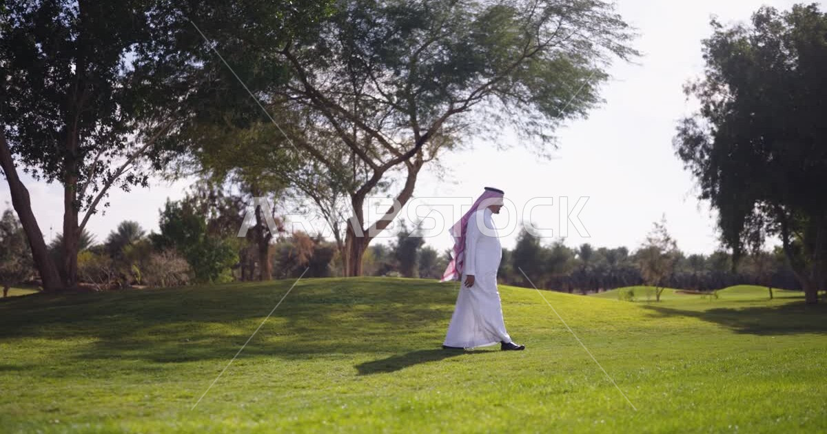 A Saudi Gulf Arab man spends fun times with his son, a tour in a public ...