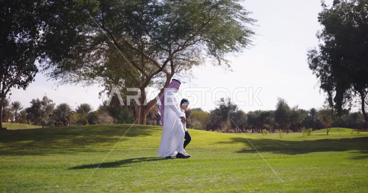A Saudi Gulf Arab man spends fun times with his son, a tour in a public ...