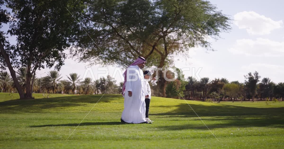 A Saudi Gulf Arab man spends fun times with his son, a tour in a public ...