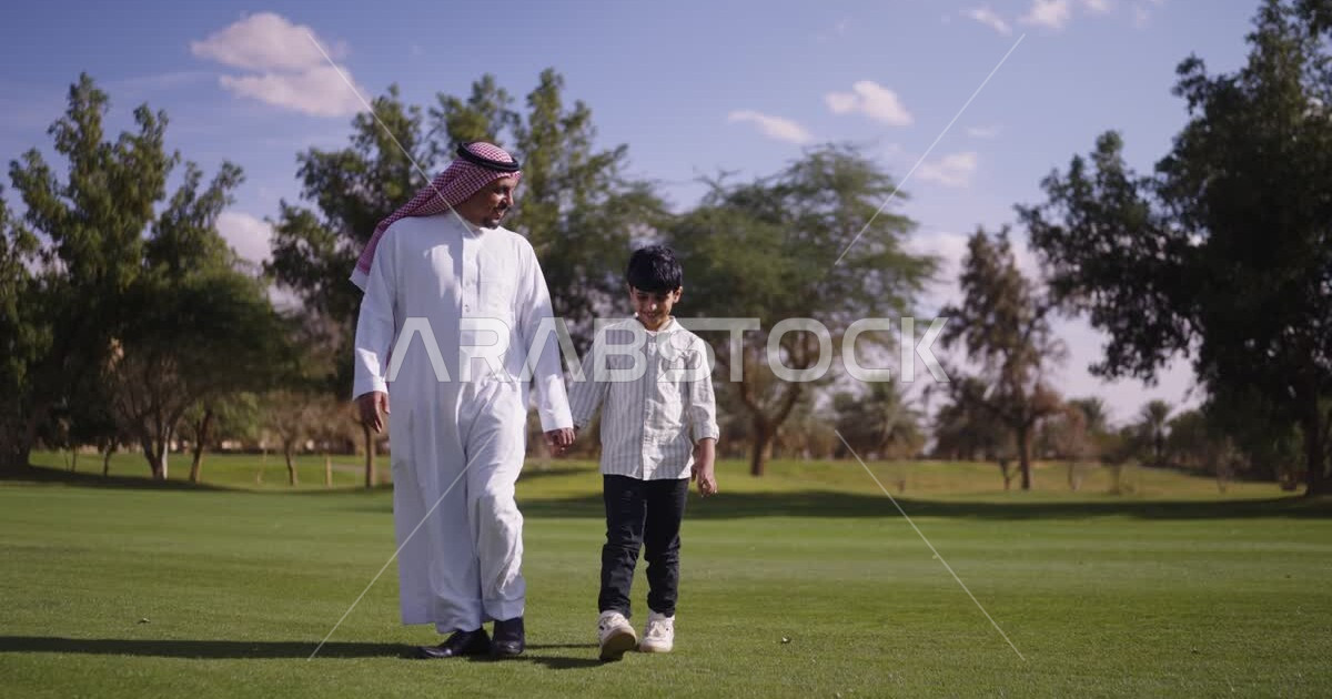 A Saudi Gulf Arab man spends fun times with his son, a tour in a public ...