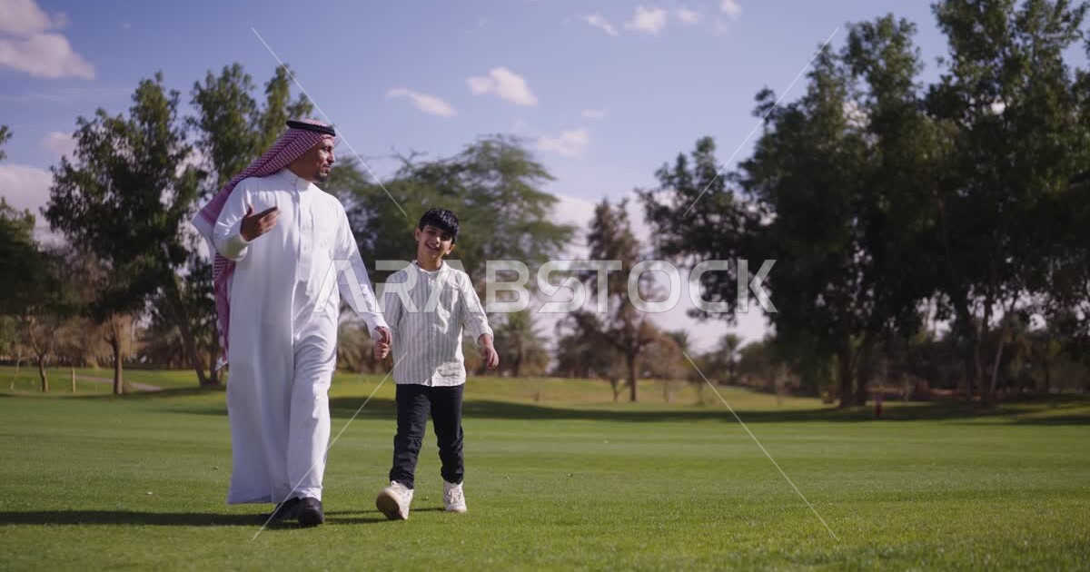 A Saudi Gulf Arab man spends fun times with his son, a tour in a public ...