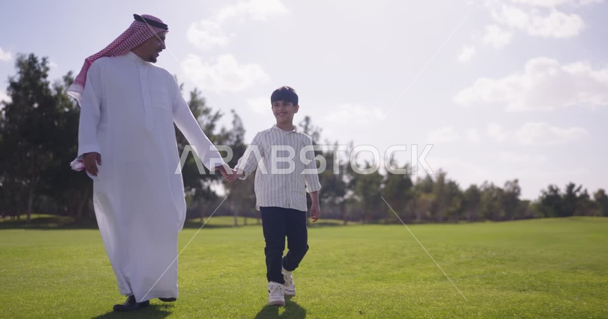 A Saudi Gulf Arab man spends fun times with his son, a tour in a public ...
