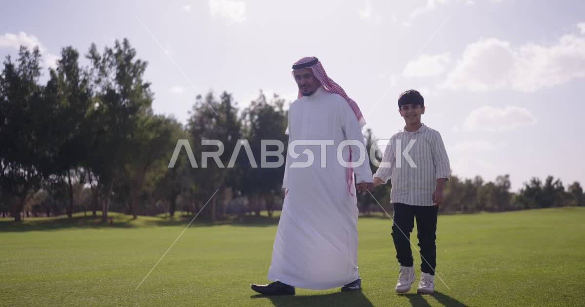 A Saudi Gulf Arab man spends fun times with his son, a tour in a public ...