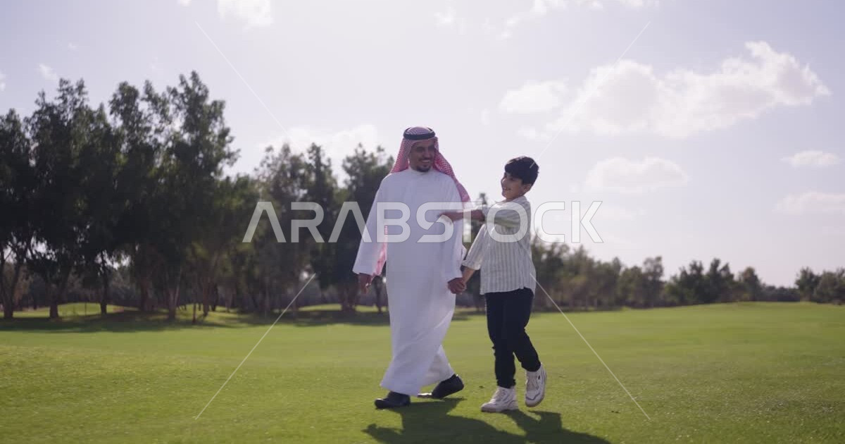 A Saudi Gulf Arab man spends fun times with his son, a tour in a public ...